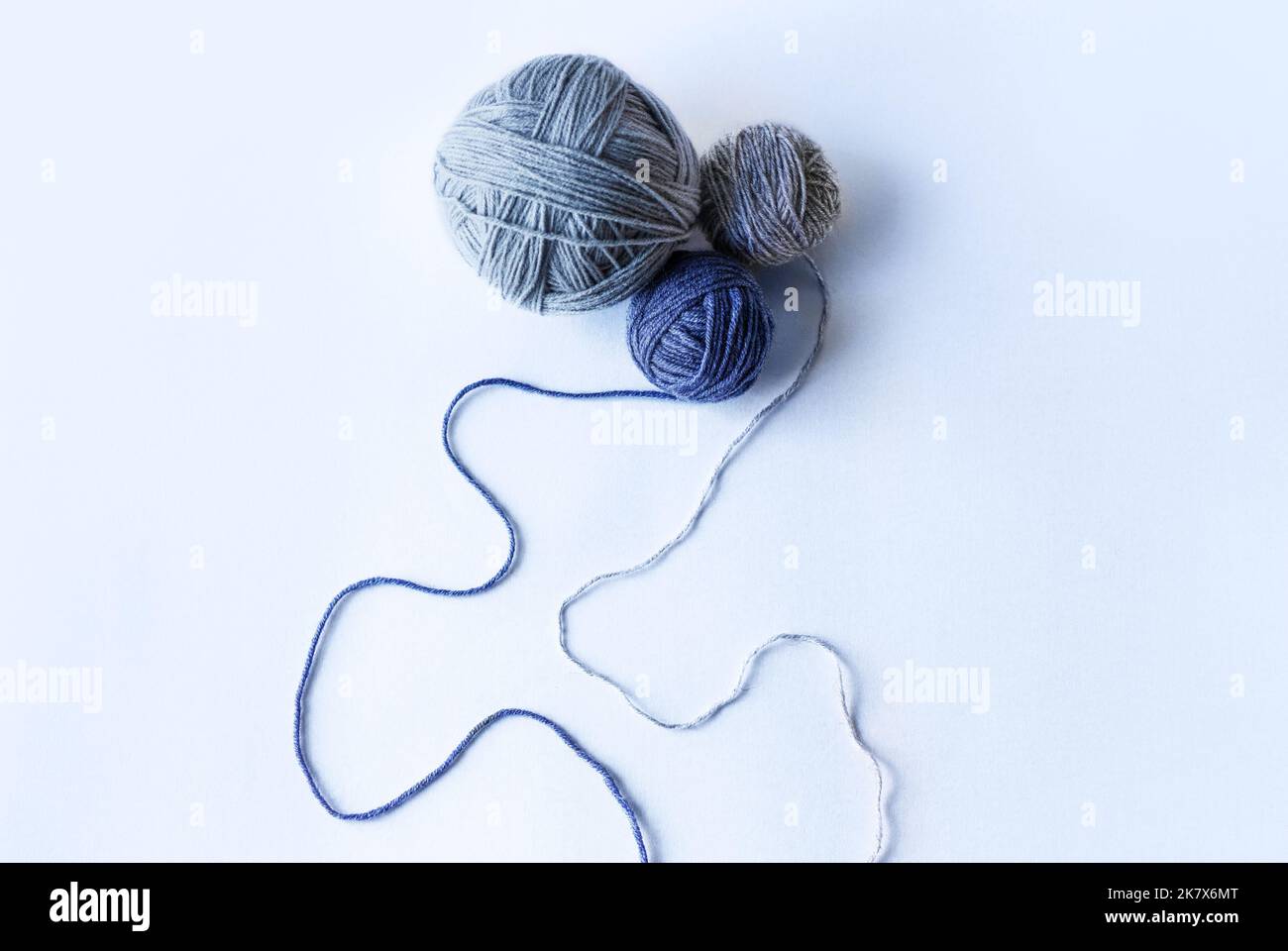 Three blue knitted wool on a blue background for knitting warm clothes ...