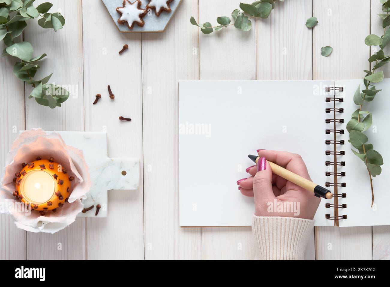 Wintertime notebook mockup with eucalyptus twigs, natural orange tea ...