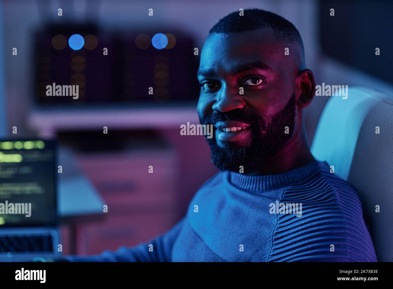 Portrait of black software engineer looking at camera while sitting at ...