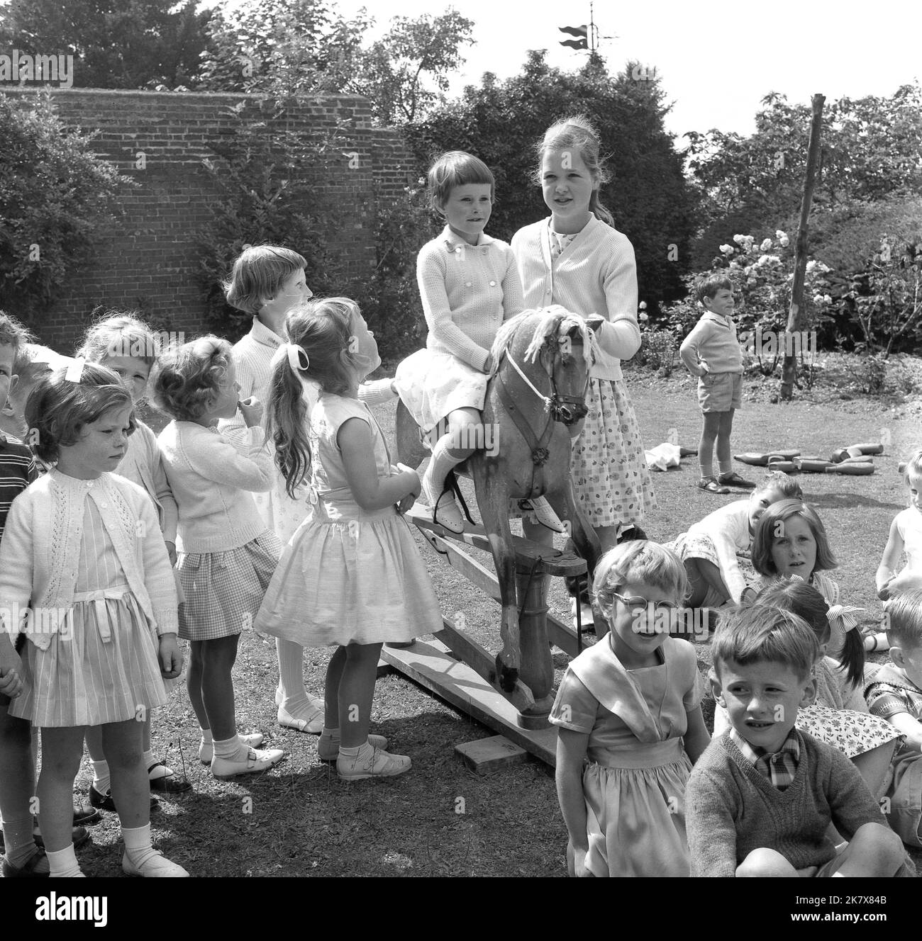 1964, historical, outside young children waiting for a ride on a ...