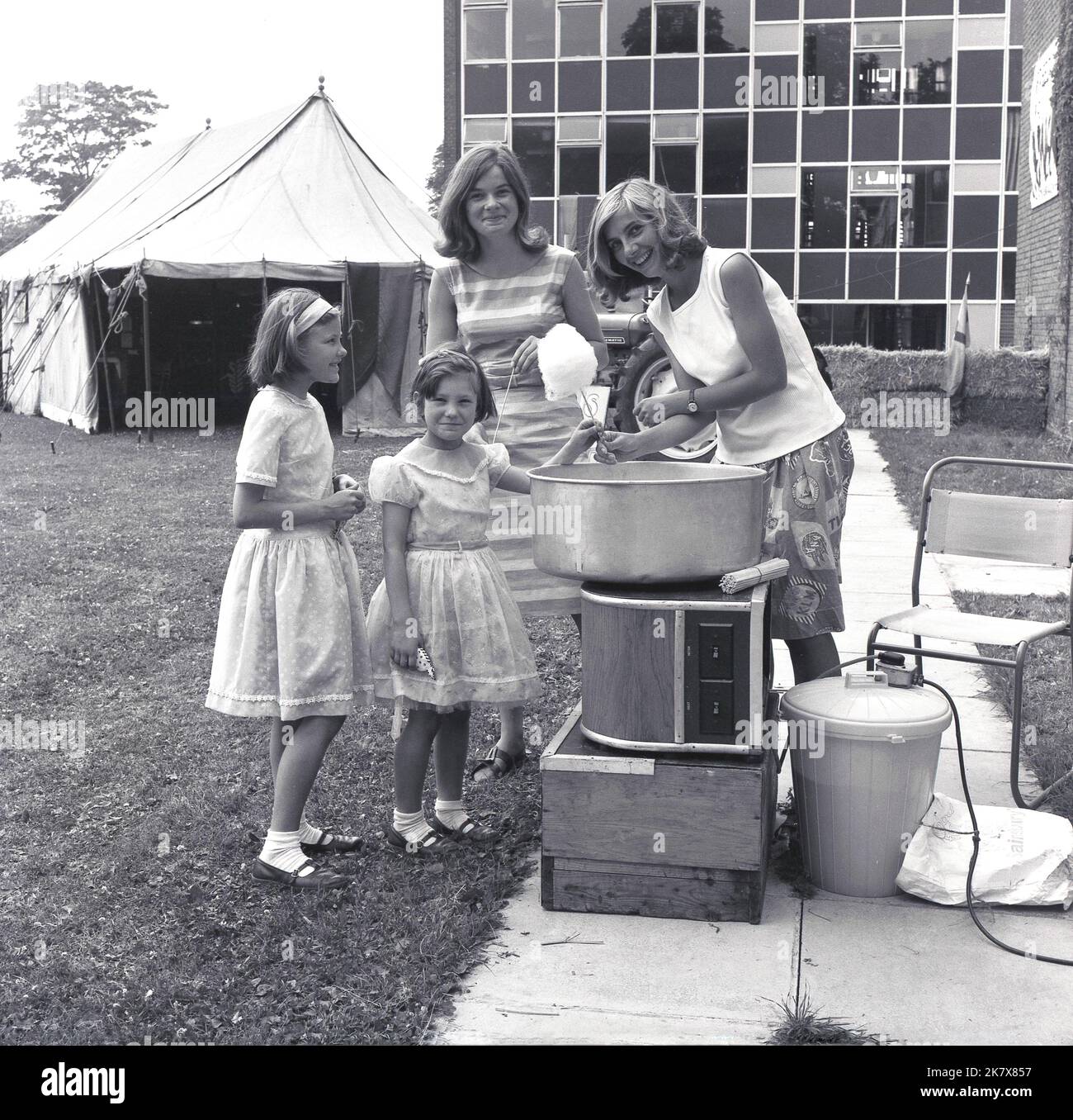 1960s, historicla, school fete, young children getting candy floss ...