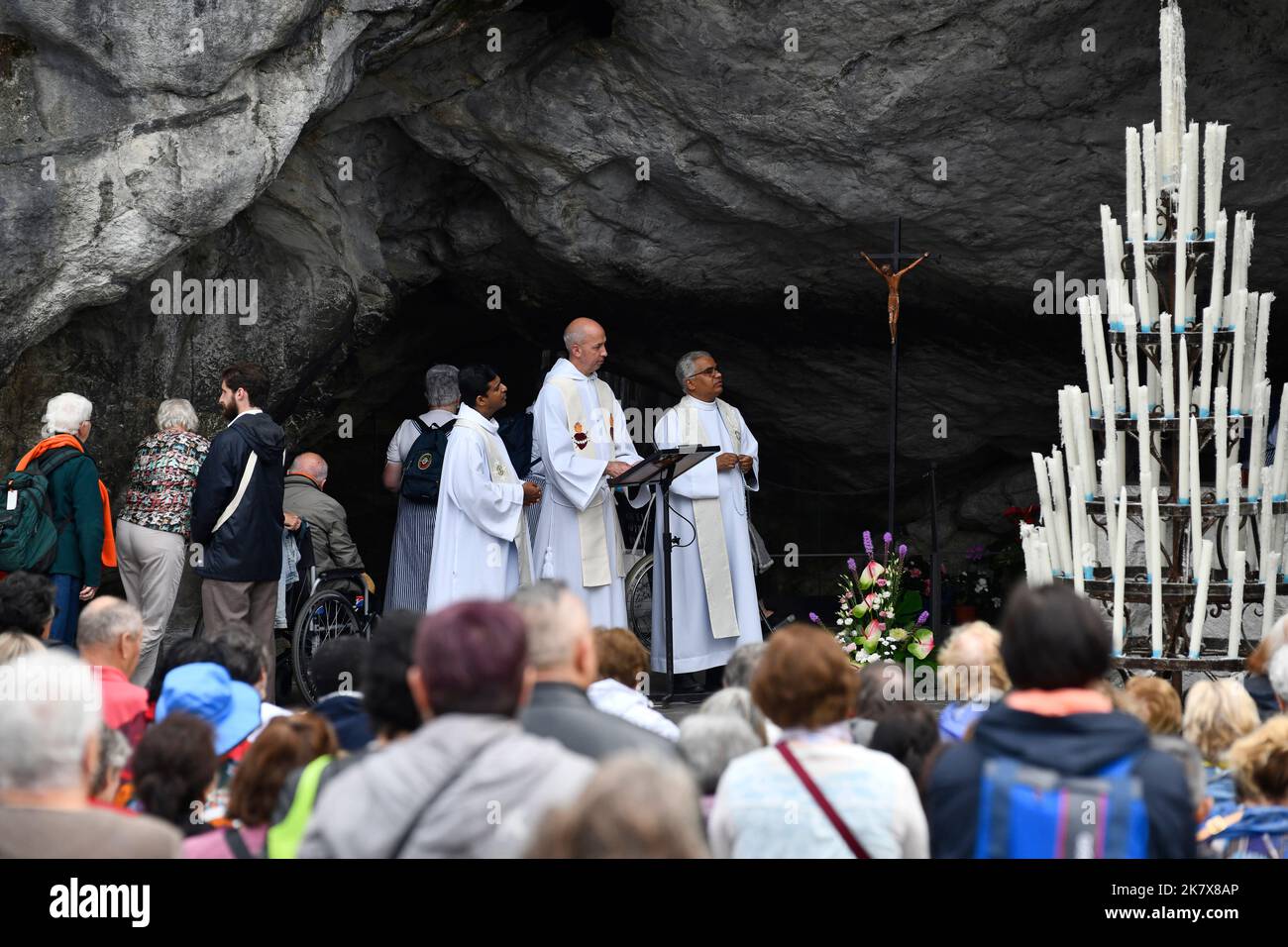 Lourdes, Hautes-Pyrénées, France. Priests taking mass at the entrance ...