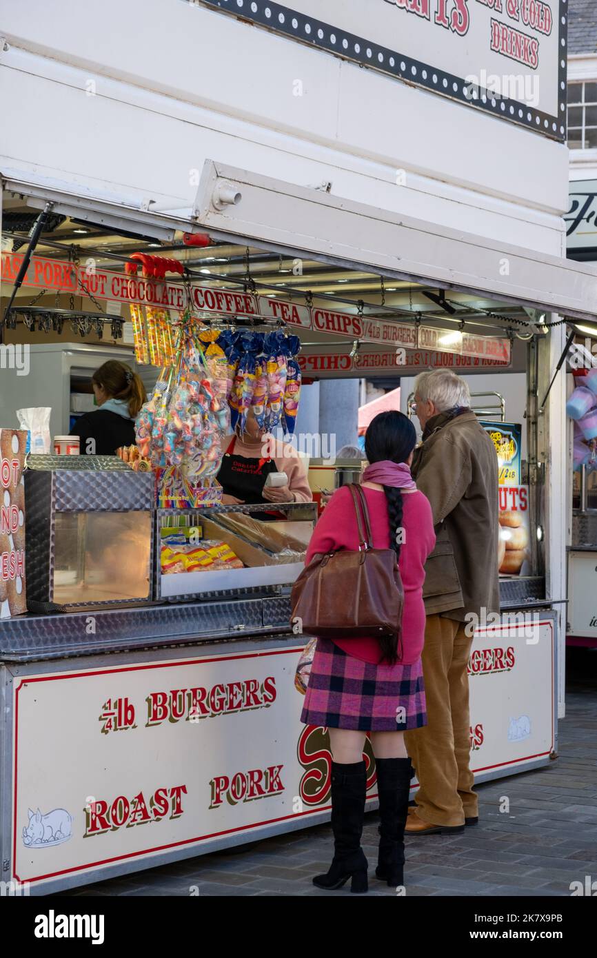 Fast food burger van at Cirencester Mop Fairs with customers (Oct22 ...