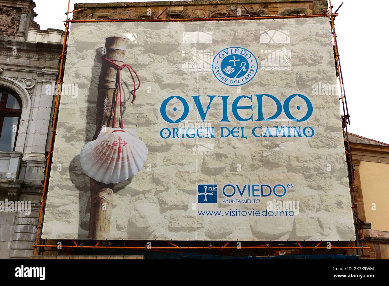 Large sign on a wall Origin of pilgrimage with an image of a stick and ...