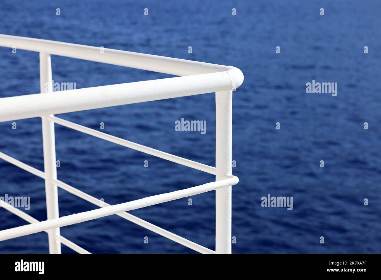 White boat railing with blue sea background Stock Photo - Alamy