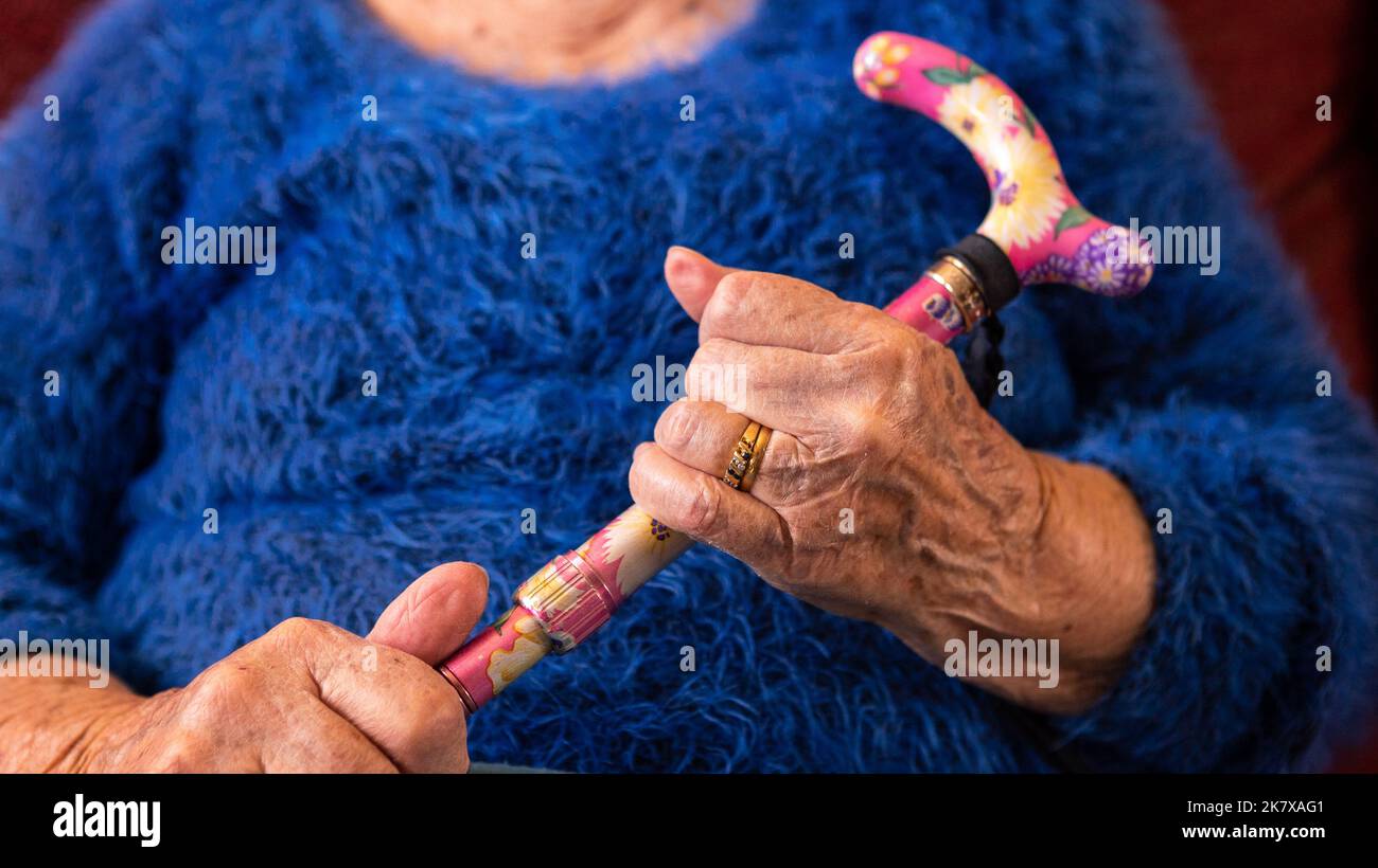 Close up of senior woman hands holding walking stick. Detail of old ...