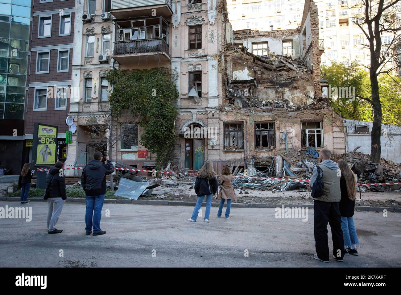 People look at the residential building destroyed by a Russian drone ...