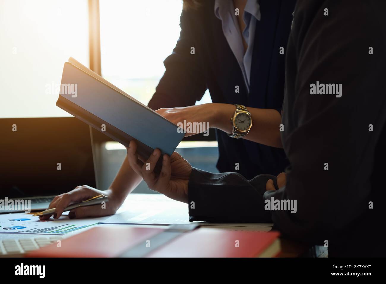 Business consultants using notebook with explaining statistics graphs ... Business consultants using notebook with explaining statistics graphs ...