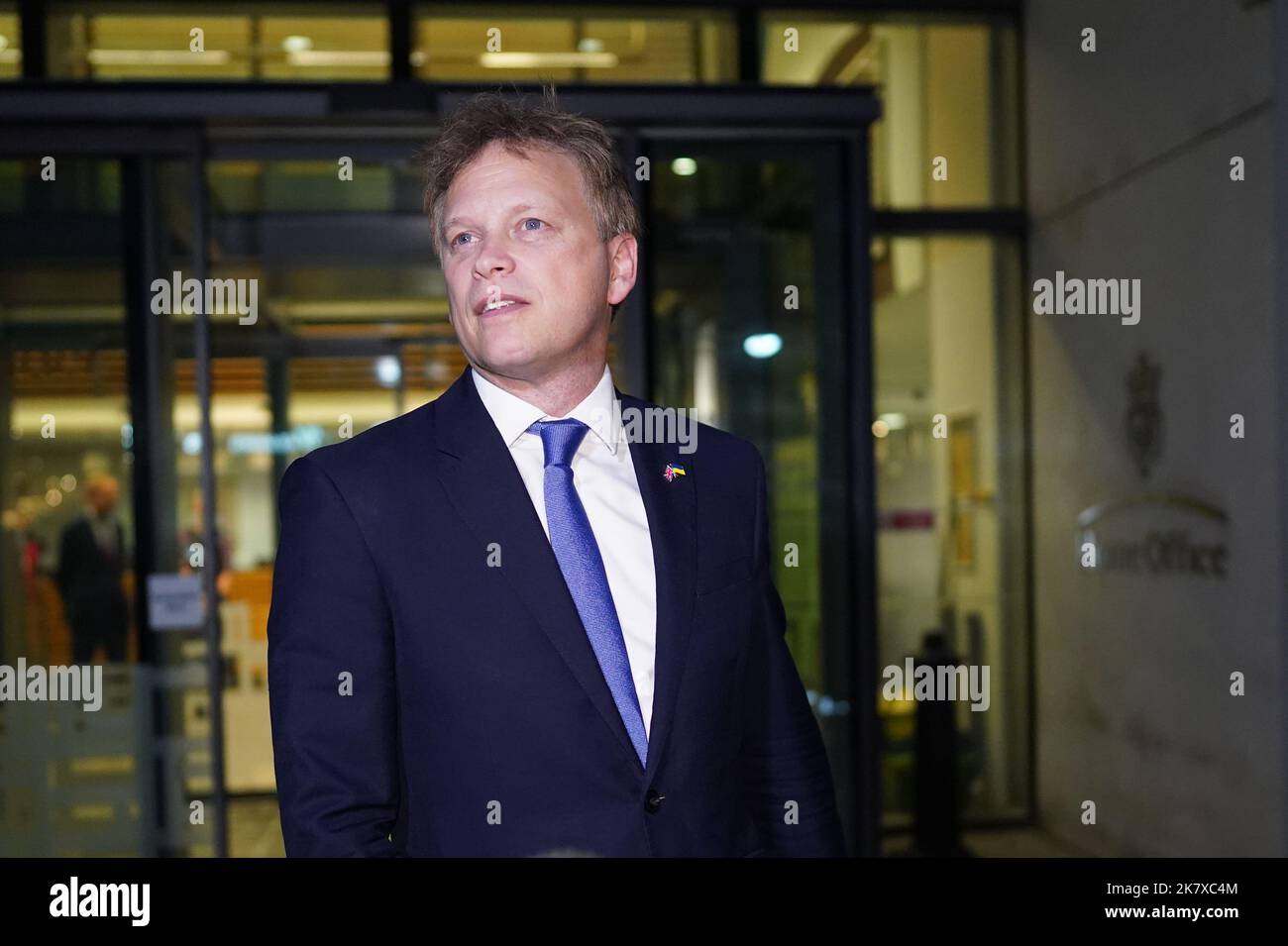 Grant Shapps speaks to the media outside the Home Office in London ...