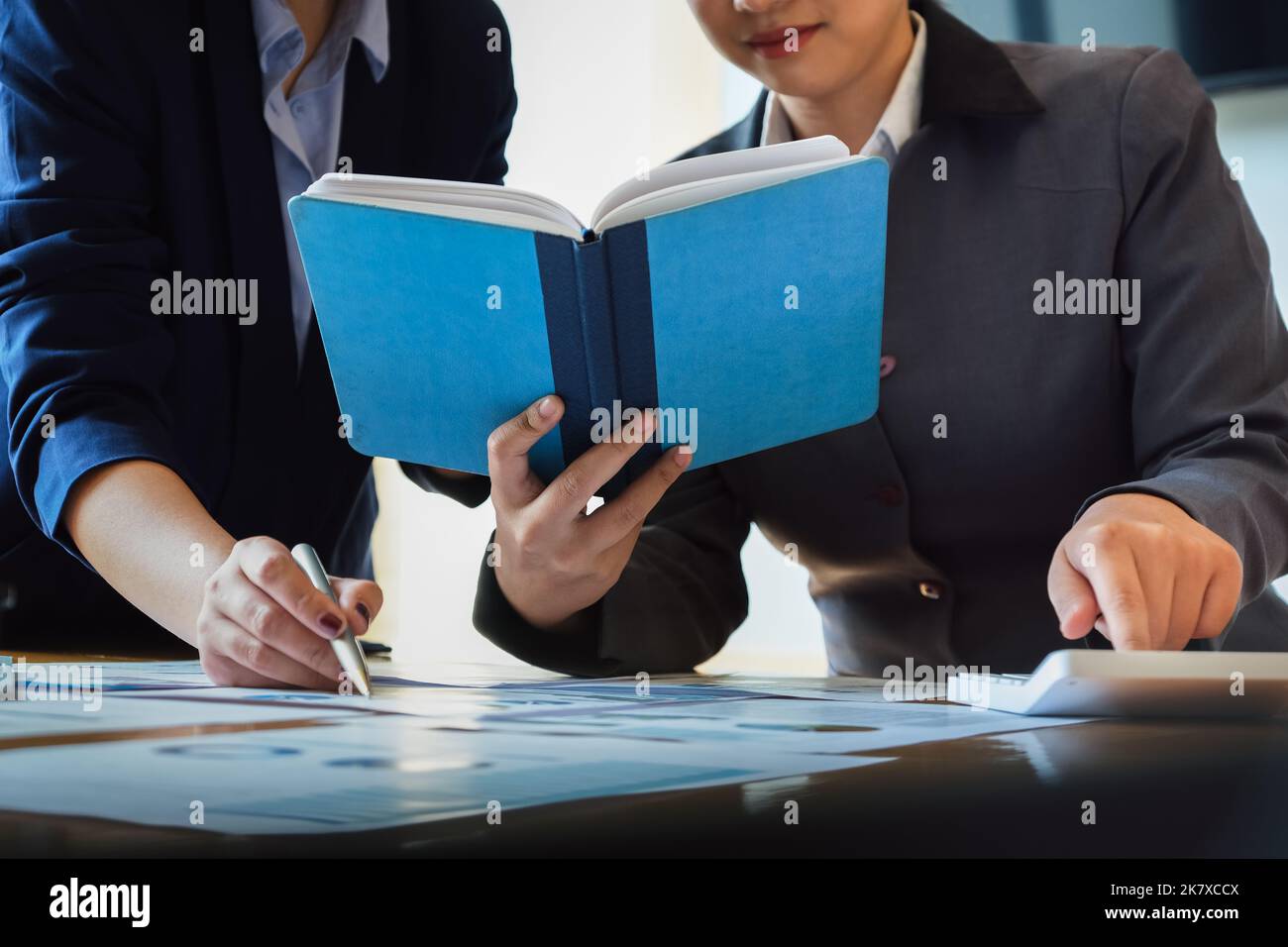 Business consultants using notebook with explaining statistics graphs ... Business consultants using notebook with explaining statistics graphs ...