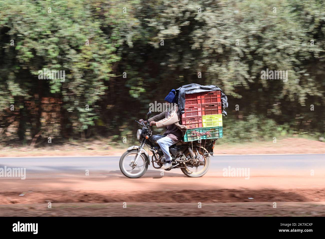 A motorcycle taxis, know as a Boda boda, in East Africa, transporting ...