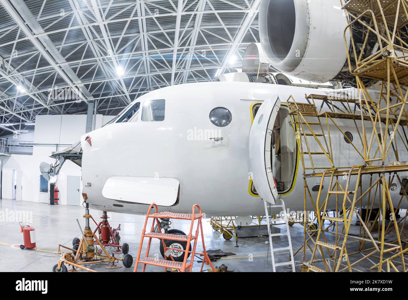 Close-up white transport airplane in the hangar. Aircraft under ...