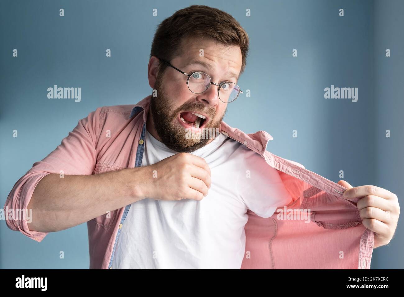 Young man has unbuttoned his shirt and shows his sweaty armpits in ...