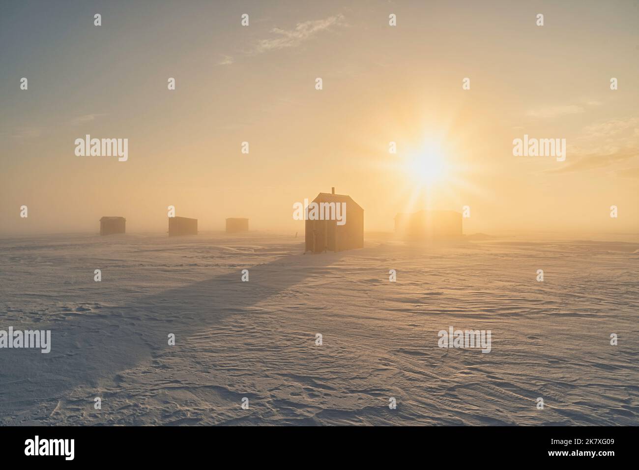 Ice fishing on a frozen harbor in rural Prince Edward Island, Canada ...