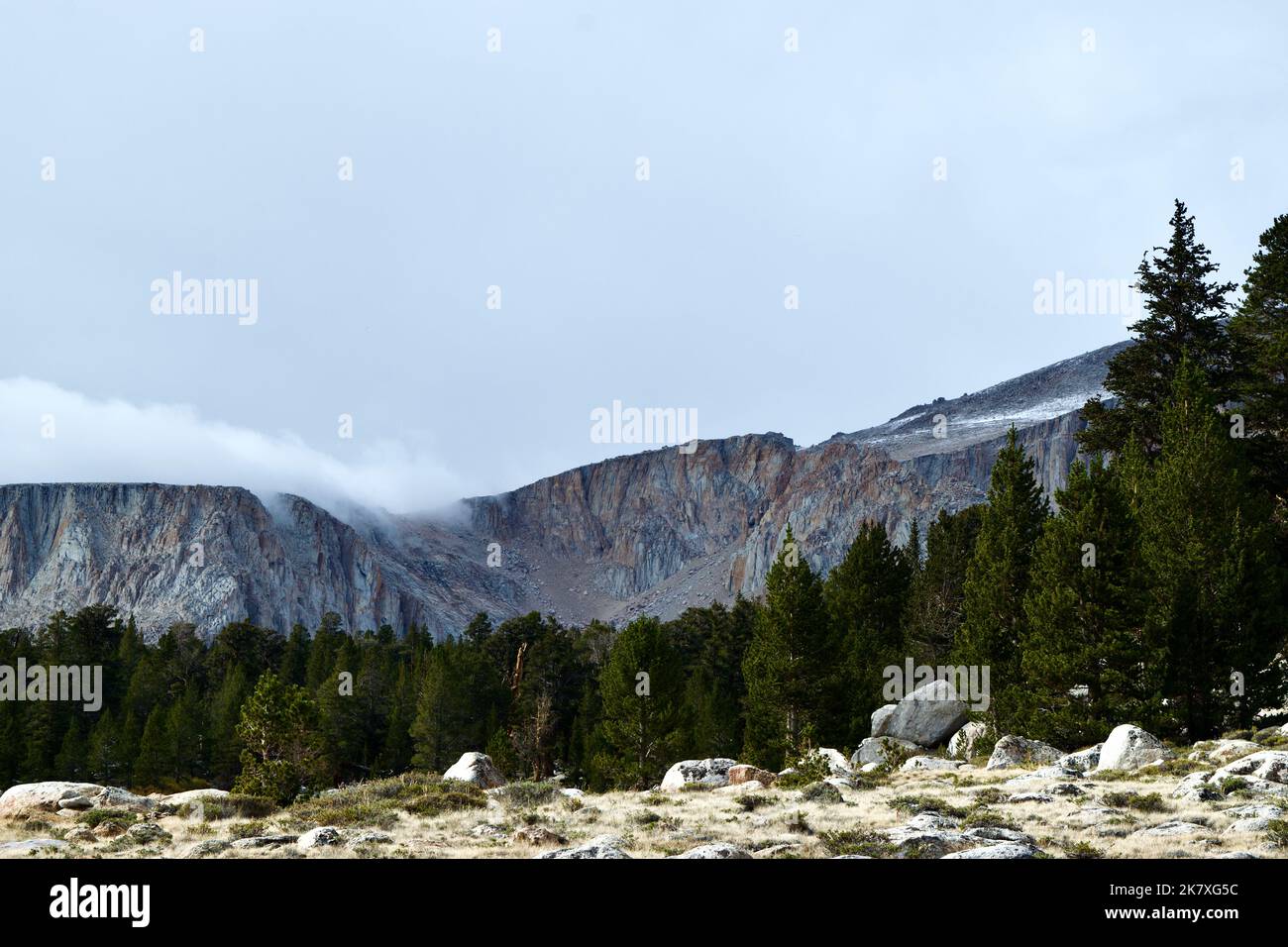 Wide view of fog creeping over mountain cliffs Stock Photo - Alamy