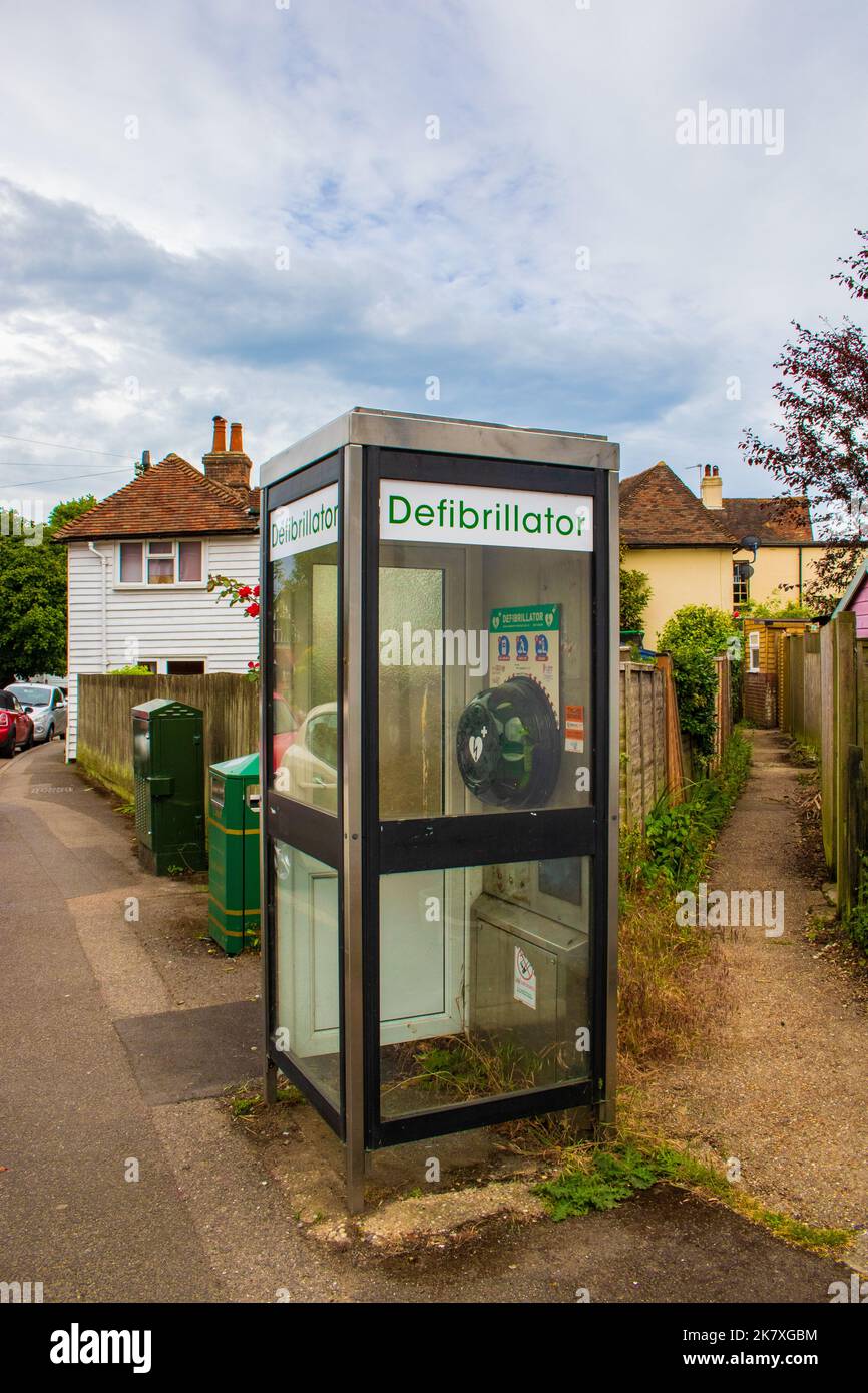 A defibrillator or AED in a telephone box on a high street in Saltwood ...