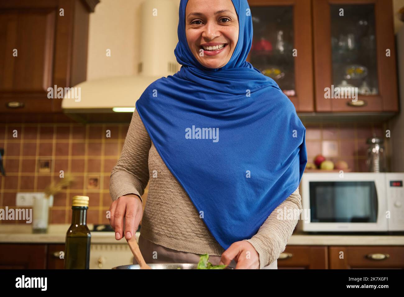 Muslim Arabic pretty woman smiling a beautiful toothy smile, standing ...
