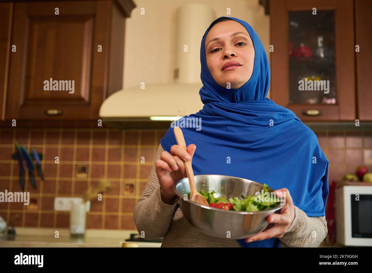 Middle Eastern Muslim pretty woman in hijab, with a bowl of healthy ...