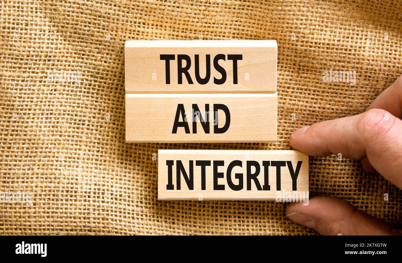 Trust and integrity symbol. Concept words Trust and integrity on wooden ...