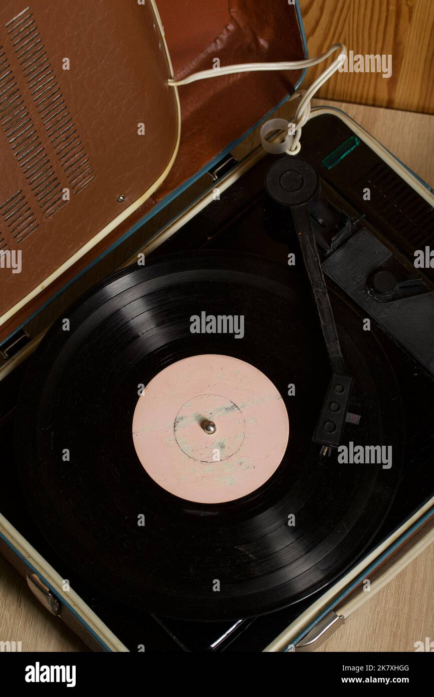 Vintage vinyl record player. The vinyl record is spinning. Close-up ...