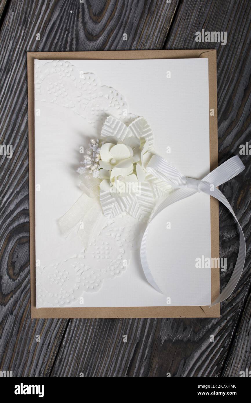 Homemade greeting card in white. With decorative elements. Ribbons ...