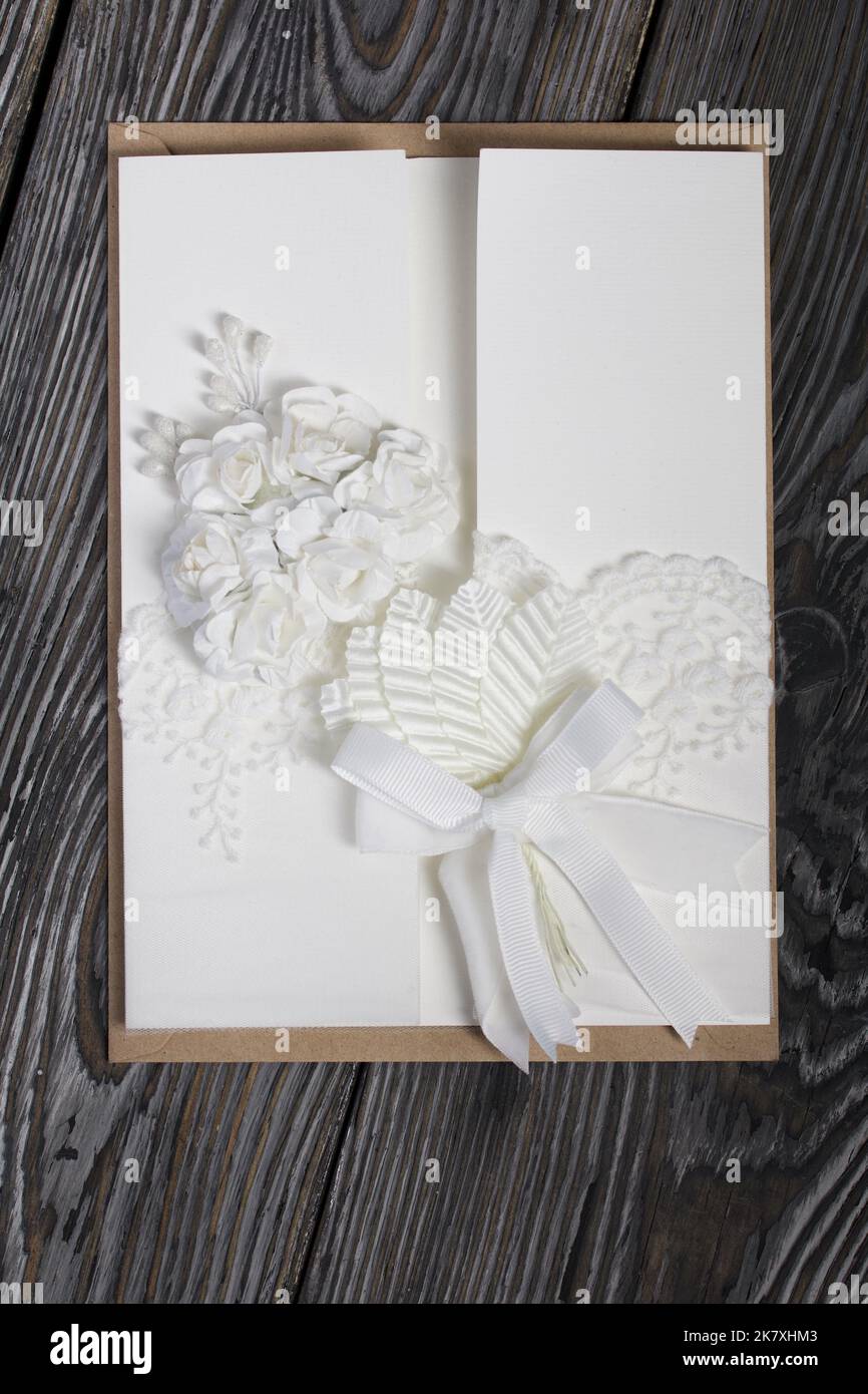 Homemade greeting card in white. With decorative elements. Ribbons ...