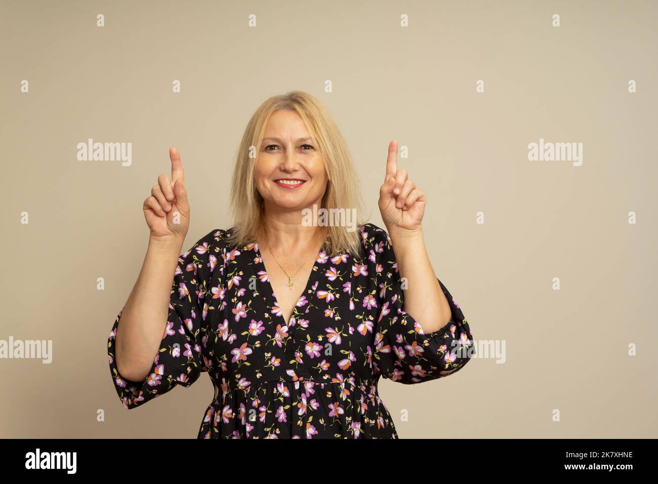 Good looking blonde female with pure healthy skin looks in amazement as ...