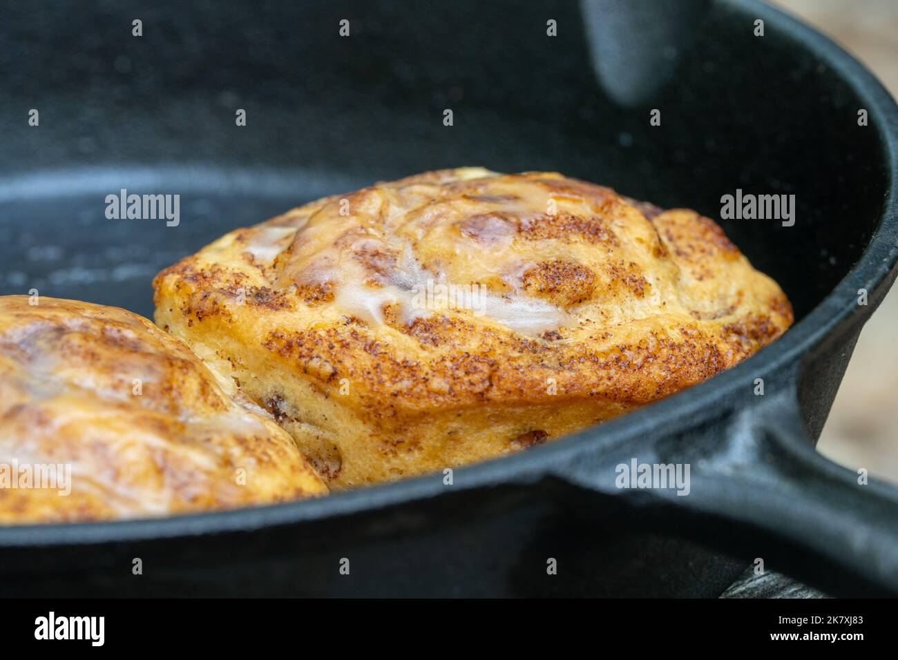 cinnamon buns cooked in cast iron pan outside on a fire Stock Photo - Alamy