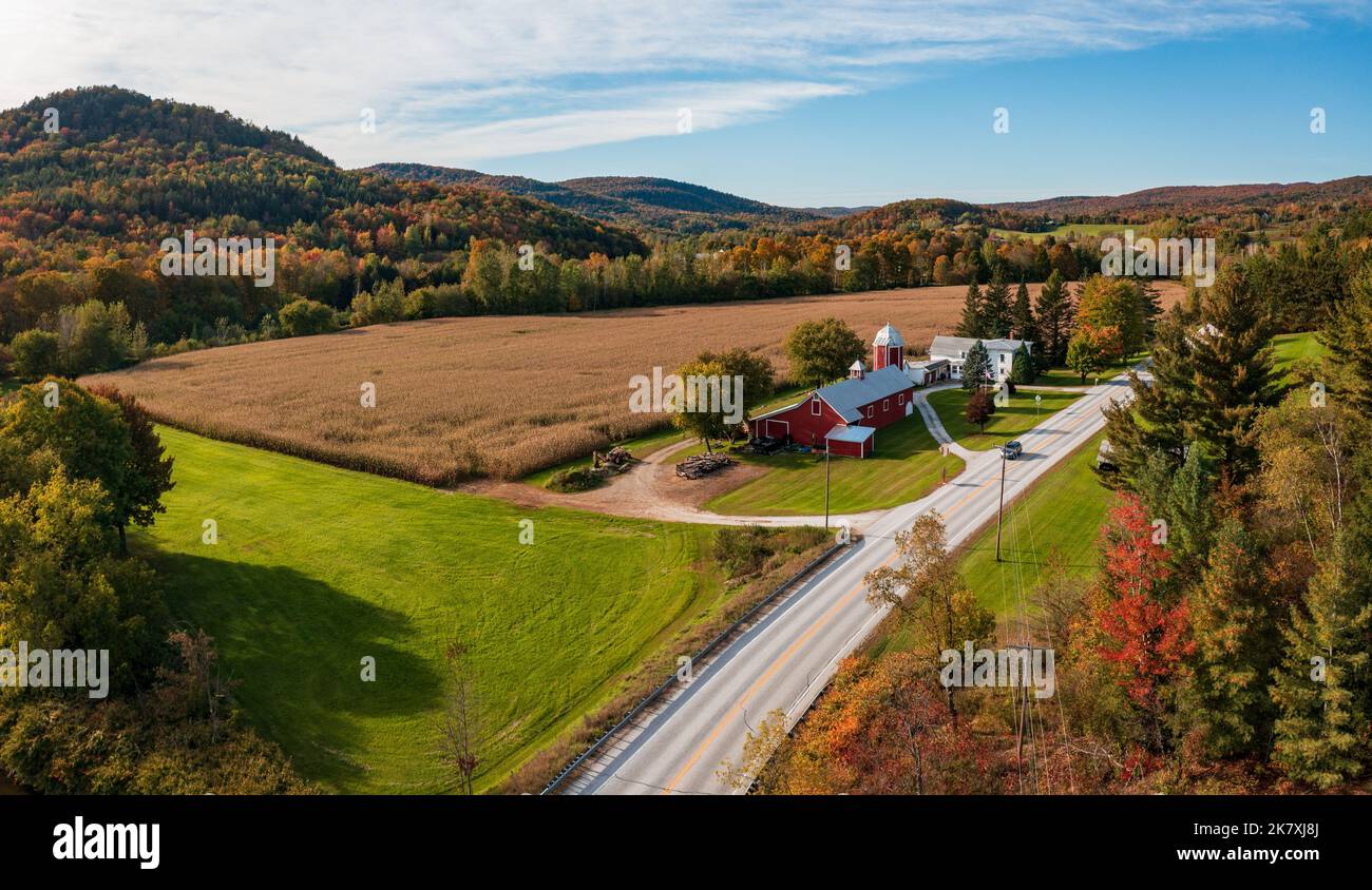 Aerial view of large red farm barn by the side of the road near ...