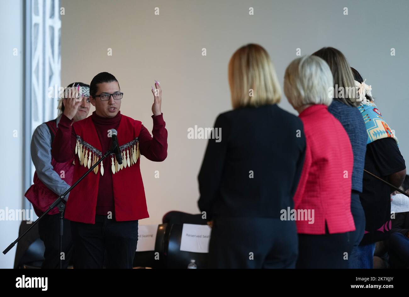 Squamish Nation councillor Khelsilem, left, raises his hands to ...
