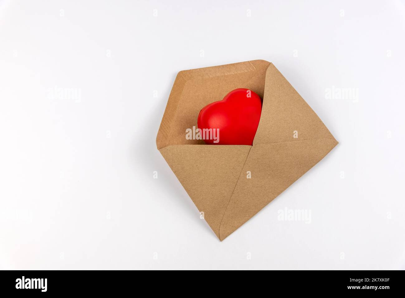 Heart shape in a brown envelope on white background Stock Photo - Alamy