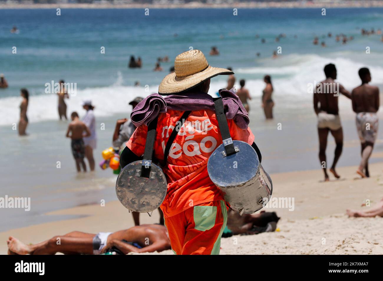 Vendor of Matte Leão drink at Copacabana beach. Man walks with coolers ...