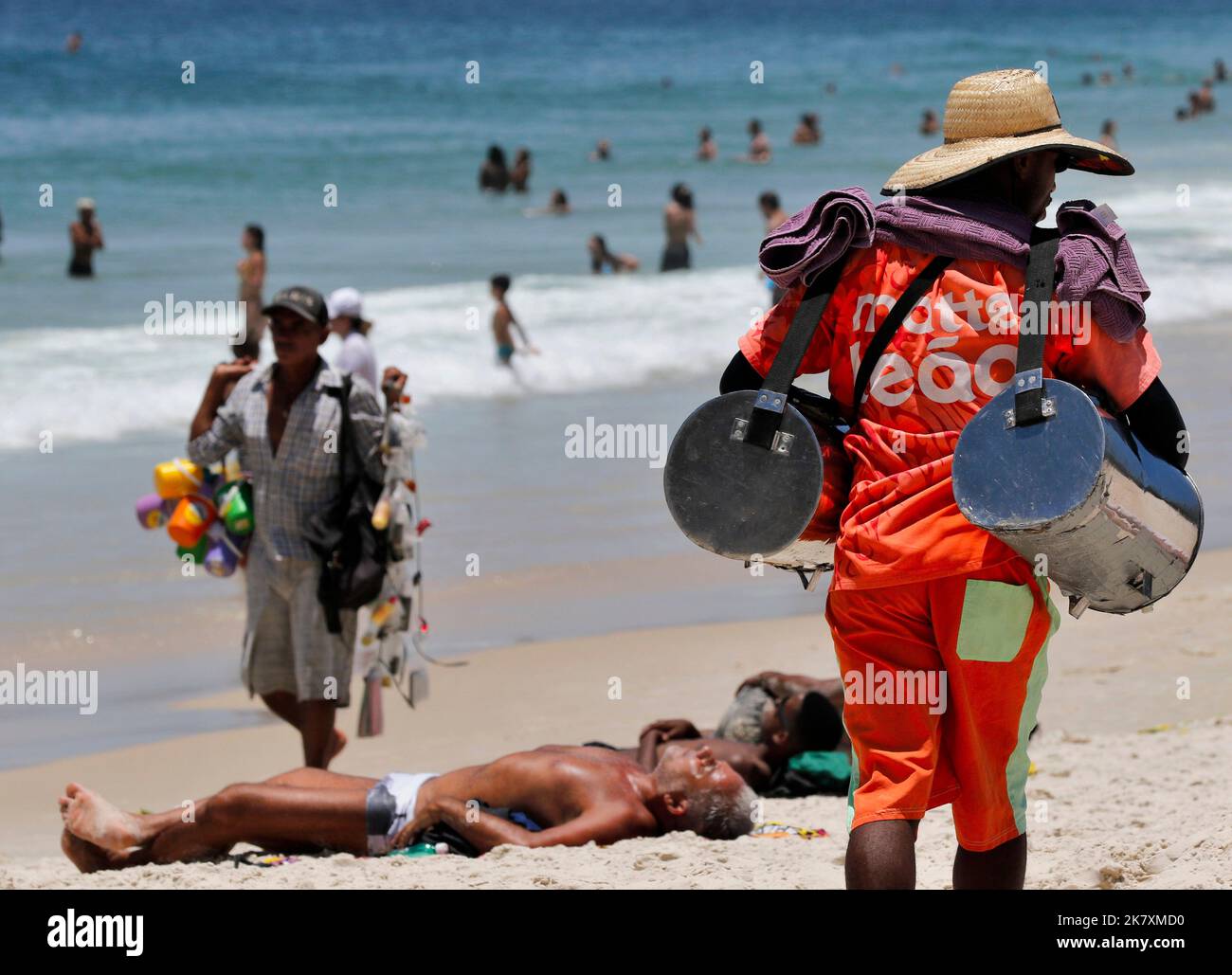 Vendor of Matte Leão drink at Copacabana beach. Man walks with coolers ...