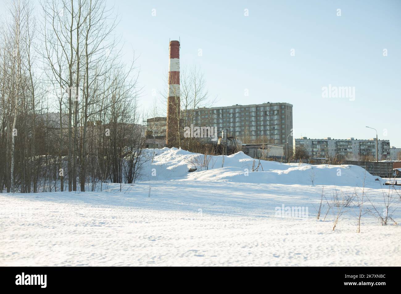 Pipe factory in city. Industrial landscape. Plant in winter. Pipe is ...