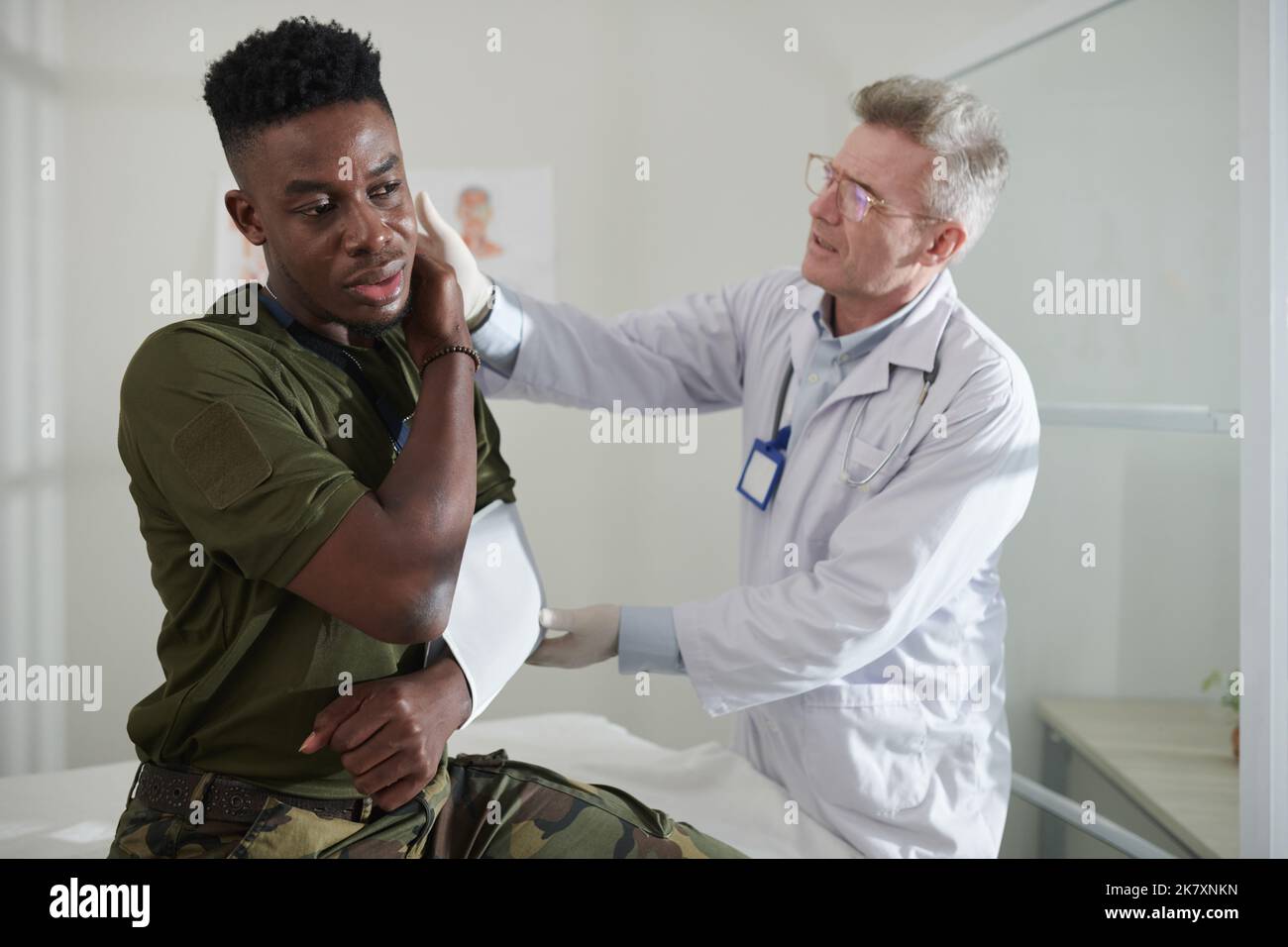 Military man with broken arms complaining about pain in his shoulder ...