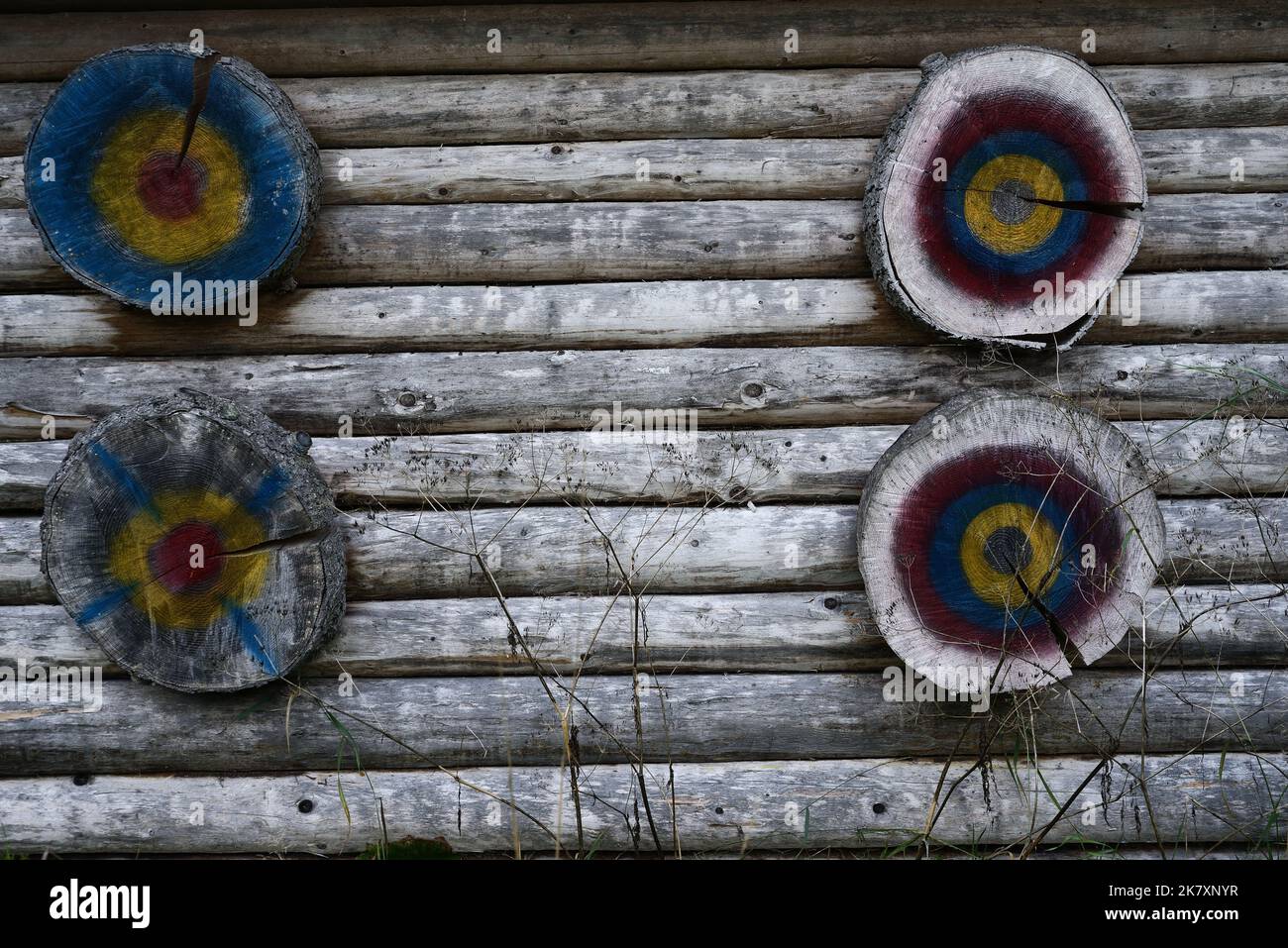 wooden round targets for archery on a log wall Stock Photo - Alamy