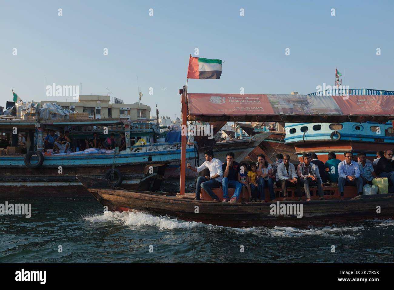 People ride an Abra, a traditional water taxi that crosses the Dubai ...
