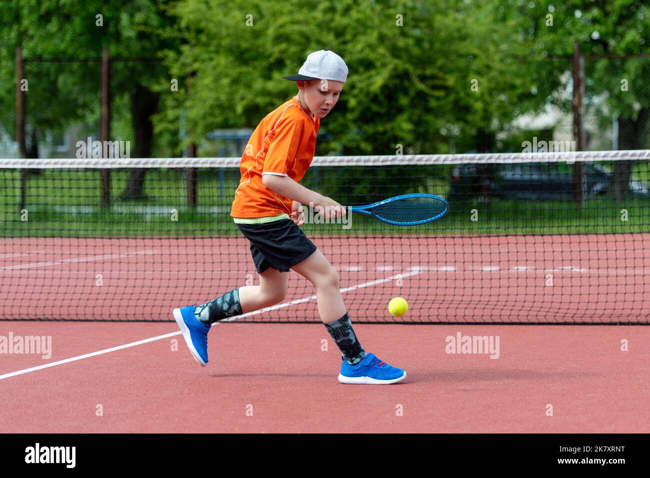 Child with tennis racket on tennis court. Training for young kid ...