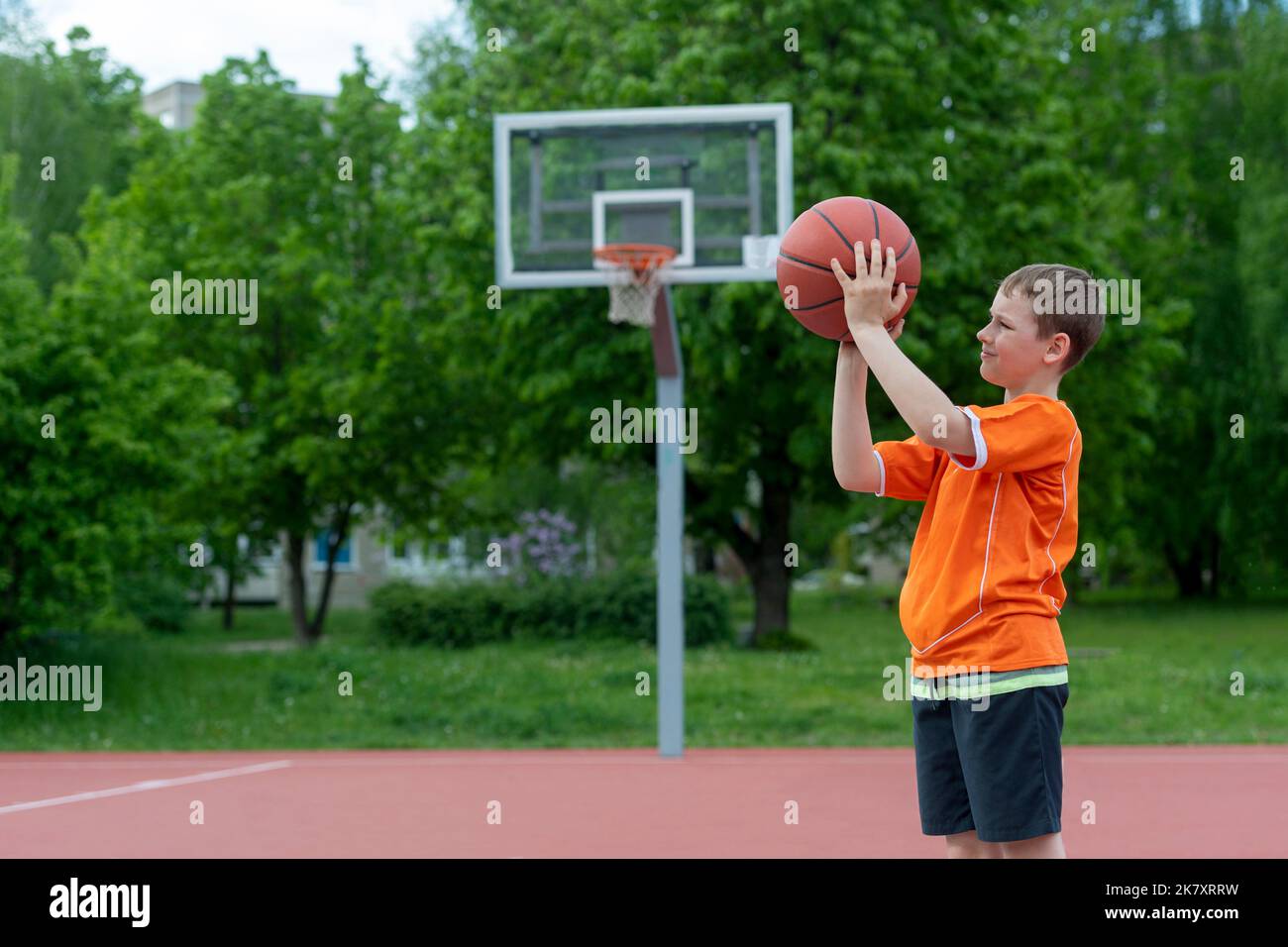 Boy playing basketball on a park court. Concept of a sports lifestyle ...