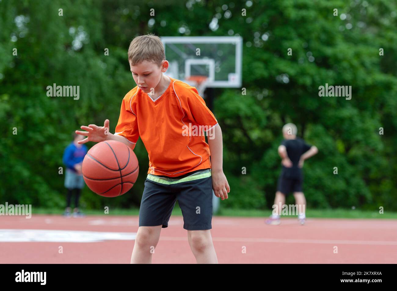 Boy playing basketball on a park court. Concept of a sports lifestyle ...