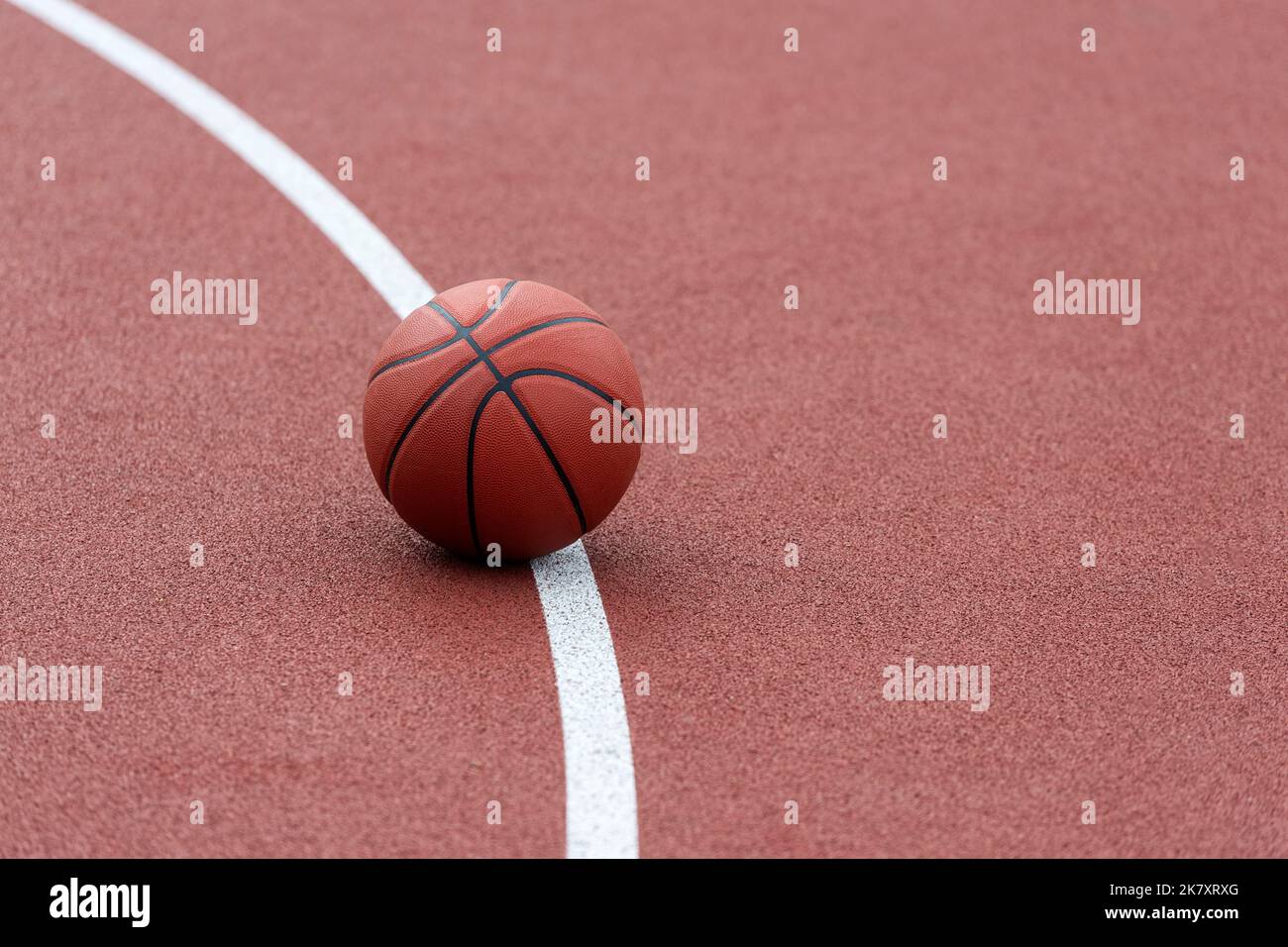 Orange basketball on brown court of gymnasium sport floor. Street ...