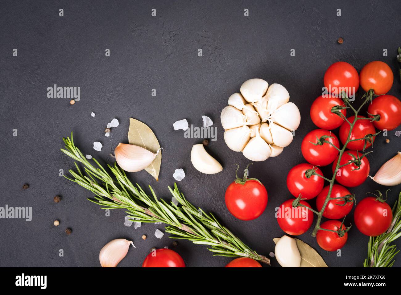 Food background - variety of seasonings, herbs and vegetables over dark ...