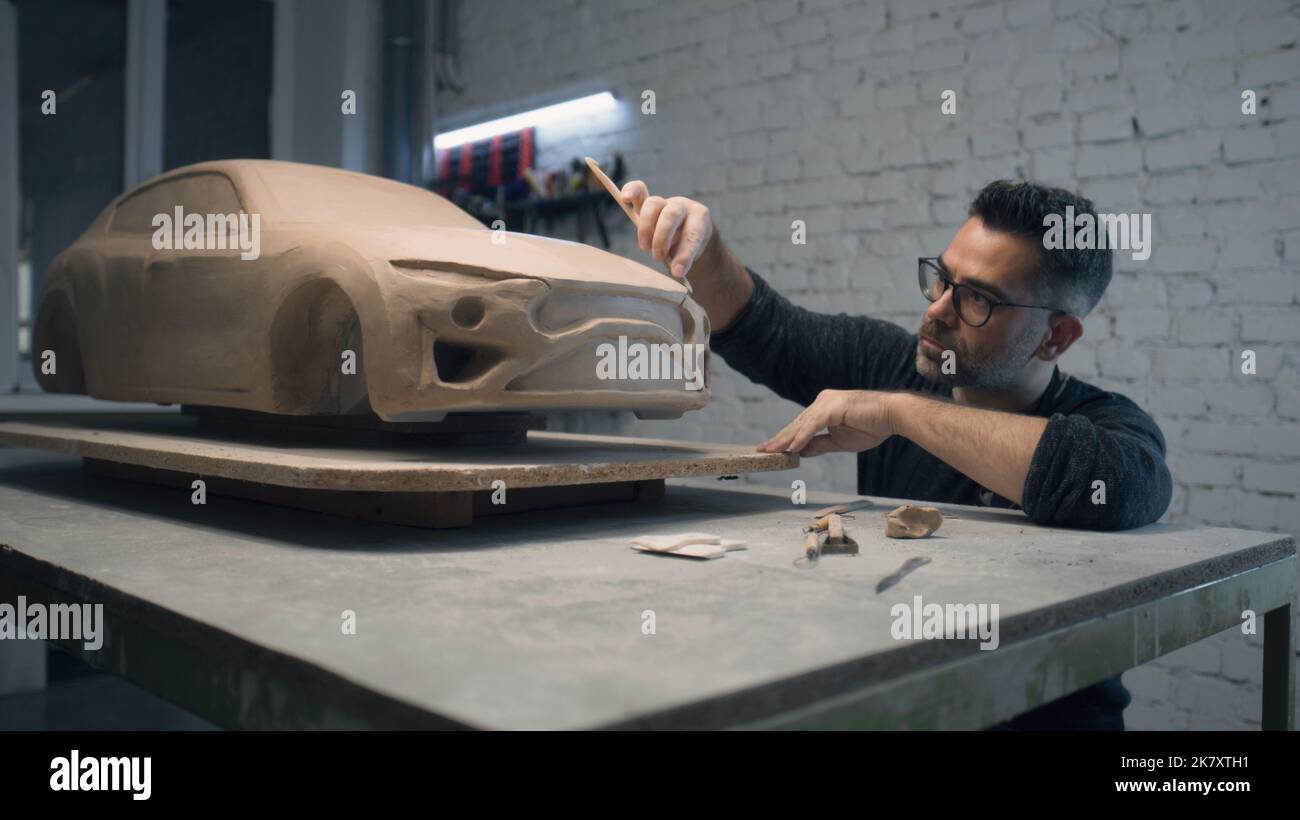 Senior car designer works on the sculpture of the eco friendly car ...