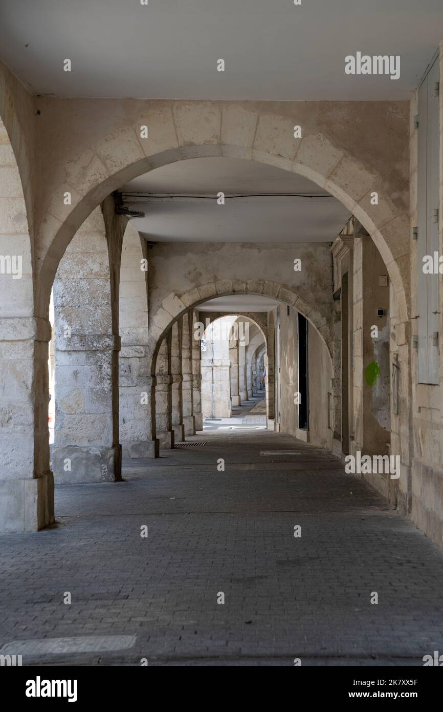 Ancient stone archways in the old quarter of La Rochelle, Charente ...