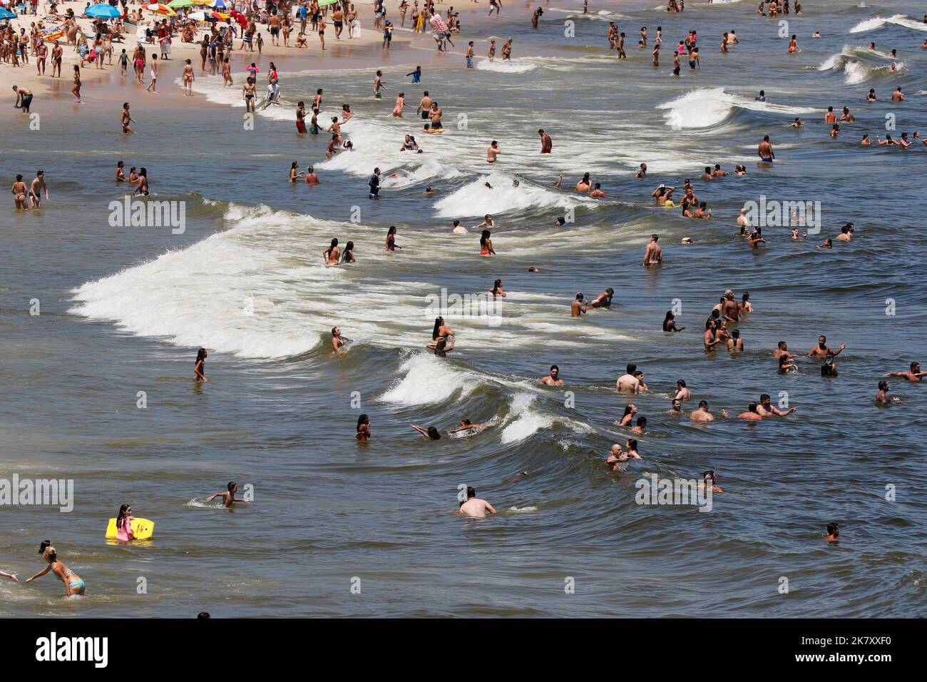 People bathing at beach near shore. Crowd enjoy summer day swimming at ...