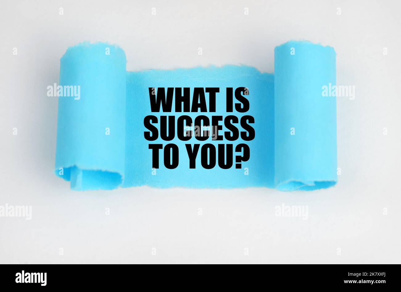 On a white surface, a blue scroll of paper with the inscription - WHAT ...