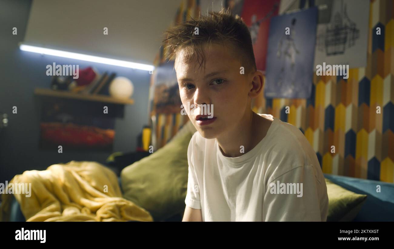 A blonde boy takes off virtual reality headset after playing an intense ...
