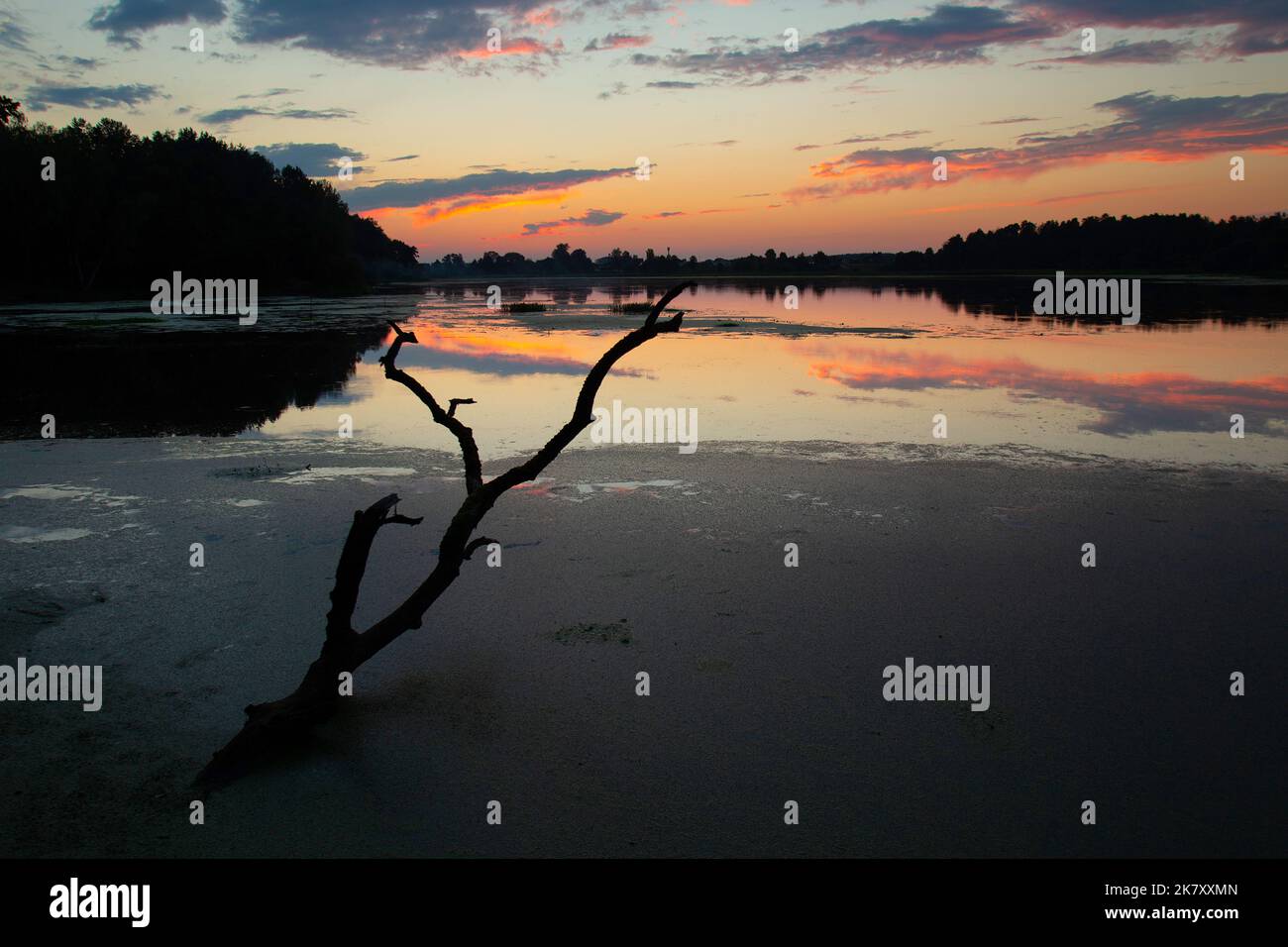 Bright cloudy sky at sunset over water reservoir in Belarus Stock Photo ...