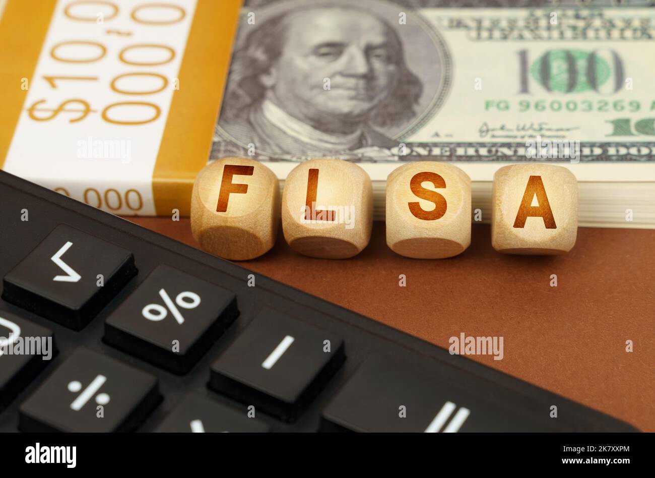 Business concept. On a brown surface are dollars, a calculator and ...