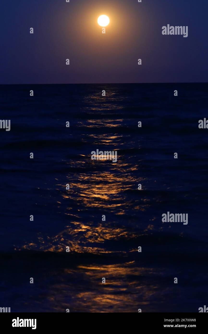 Moon rising from the sea hi-res stock photography and images - Alamy